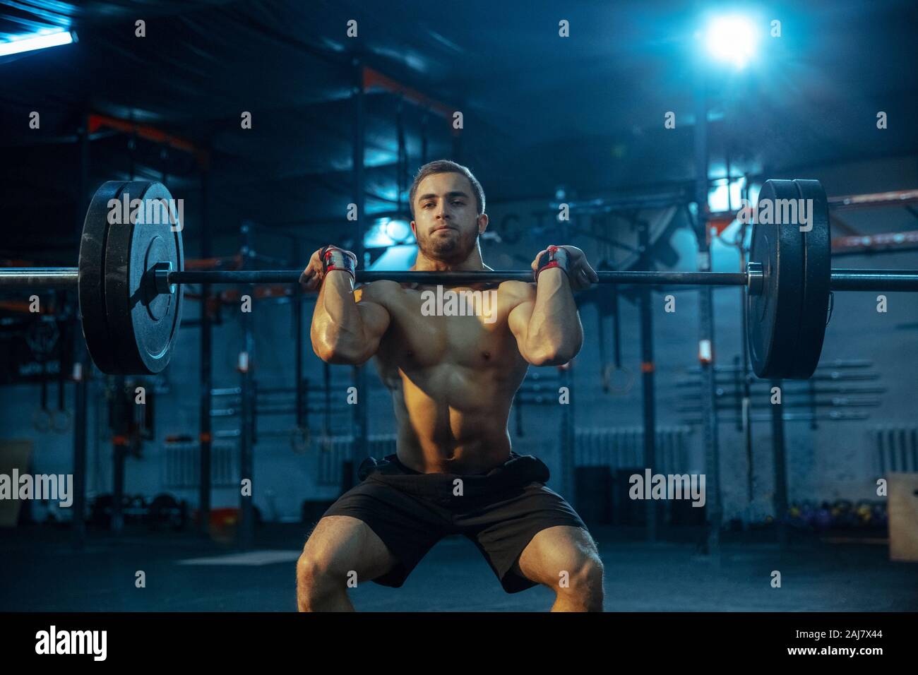 Caucasian man practicing in weightlifting in gym. Caucasian male ...