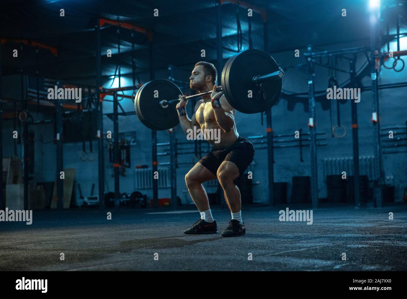 Caucasian man practicing in weightlifting in gym. Caucasian male ...