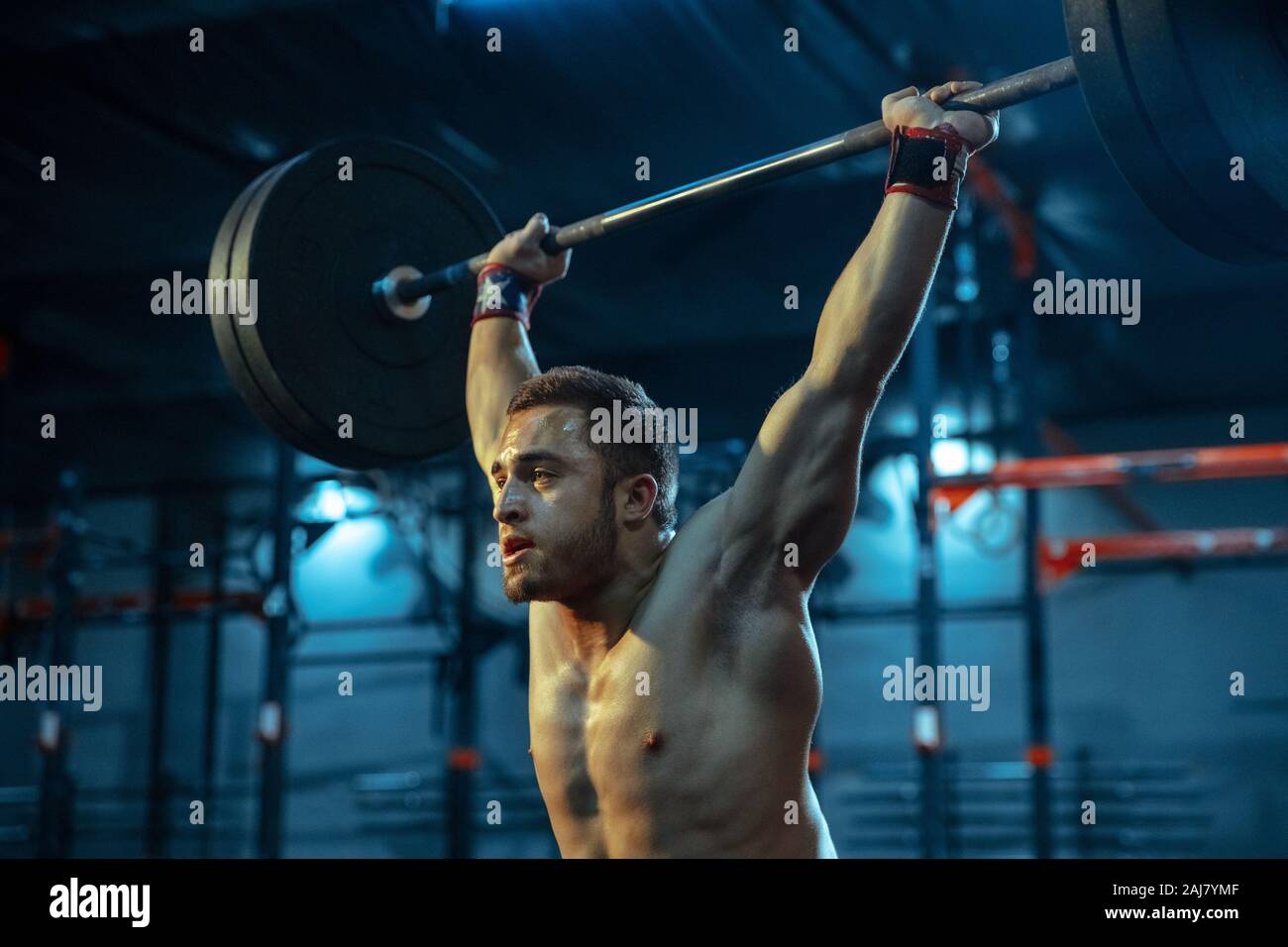 Caucasian man practicing in weightlifting in gym. Caucasian male ...