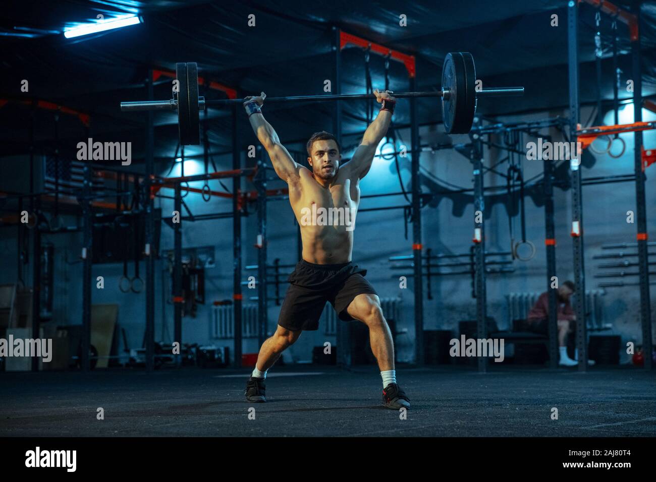 Caucasian man practicing in weightlifting in gym. Caucasian male ...