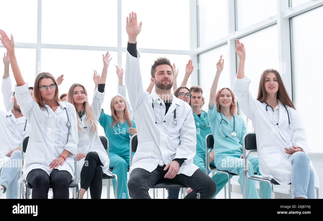 medical students raising their hands during the seminar Stock Photo - Alamy