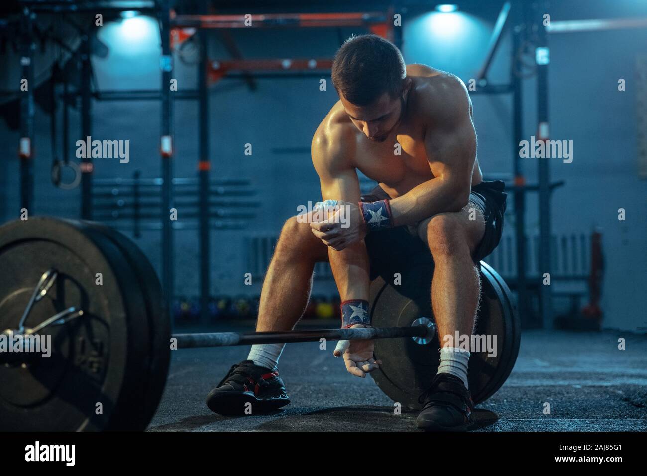 Caucasian man practicing in weightlifting in gym. Caucasian male ...