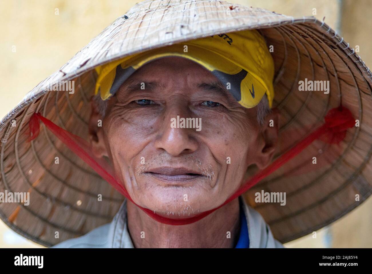 Portrait of an asian man with a conical hat and a cap Stock Photo - Alamy