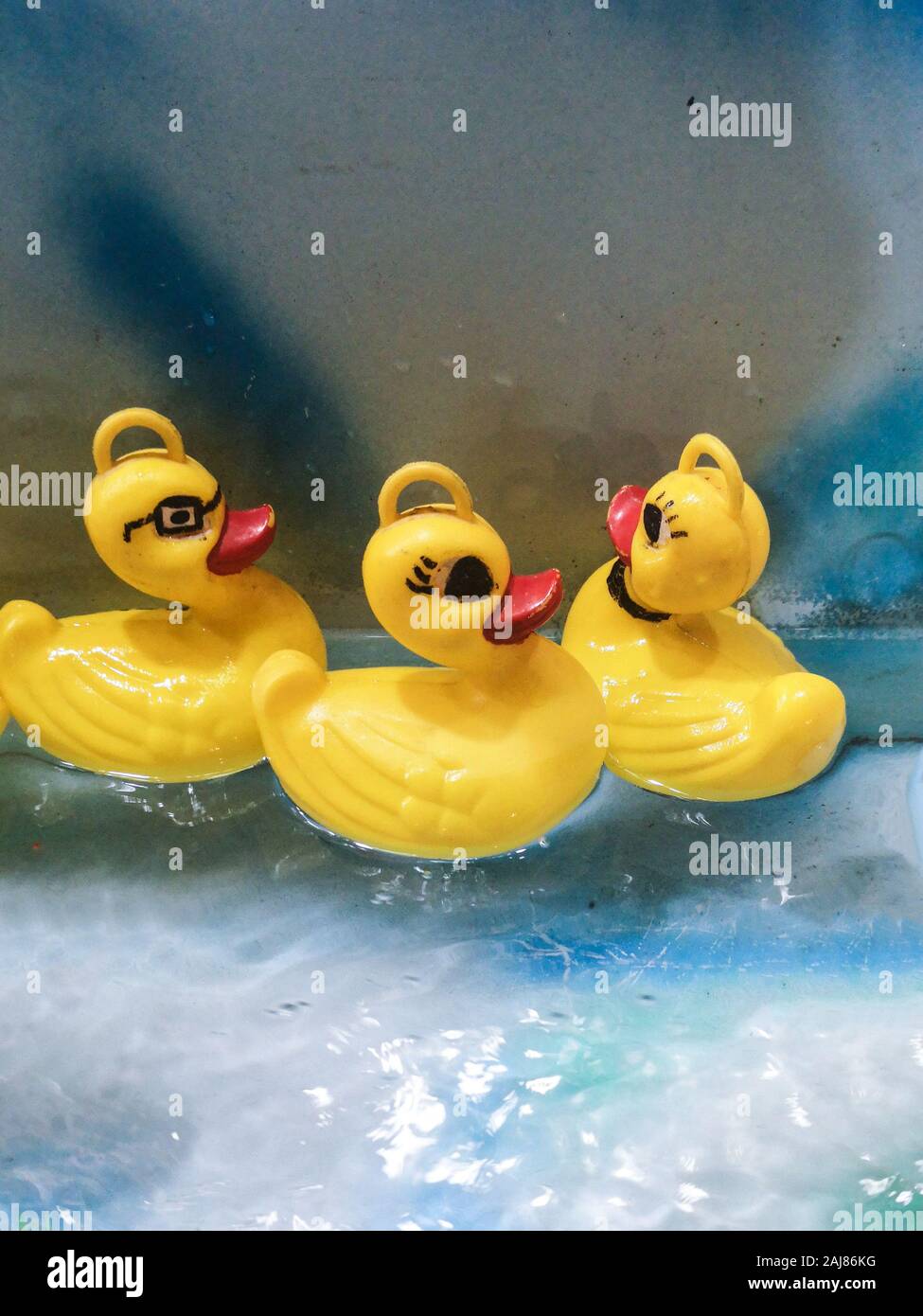 Yellow plastic ducks, game at the funfair Stock Photo - Alamy