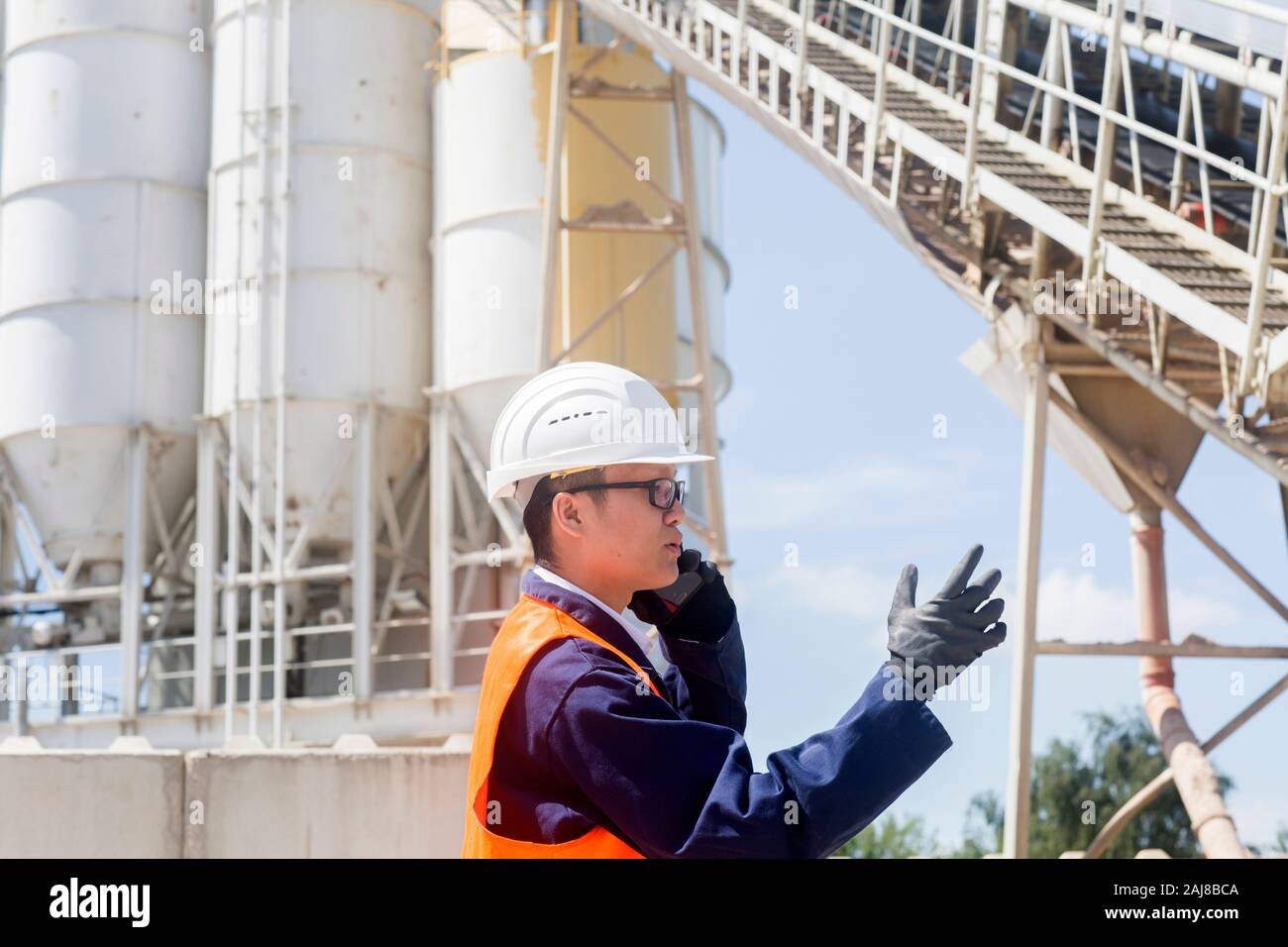 concrete worker talking to a smart phone in a concrete factory Stock ...