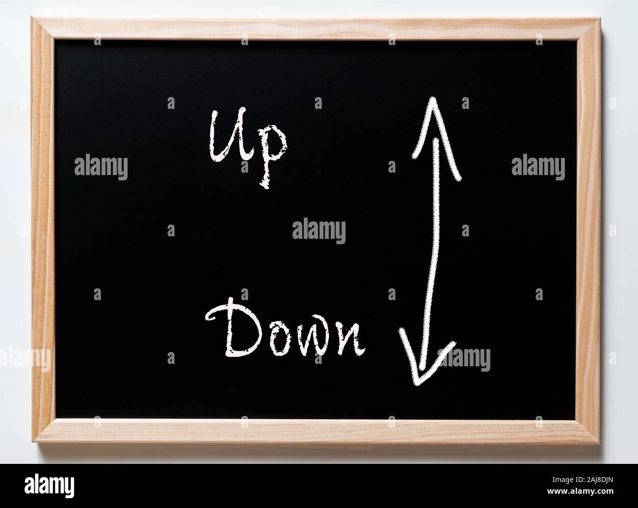 a blackboard with written the words up and down Stock Photo - Alamy
