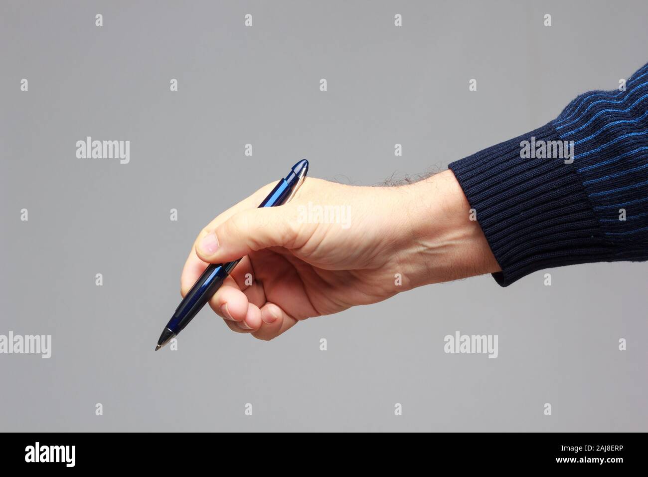 Adult hand with a pen to write ideas, sign contracts or take student ...