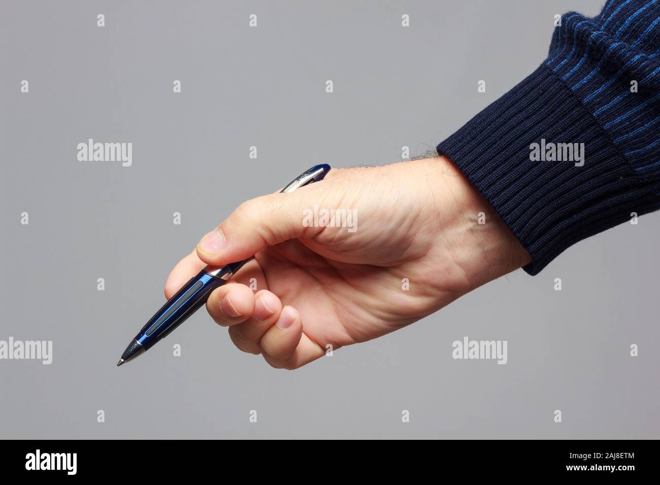 Adult hand with a pen to write ideas, sign contracts or take student ...