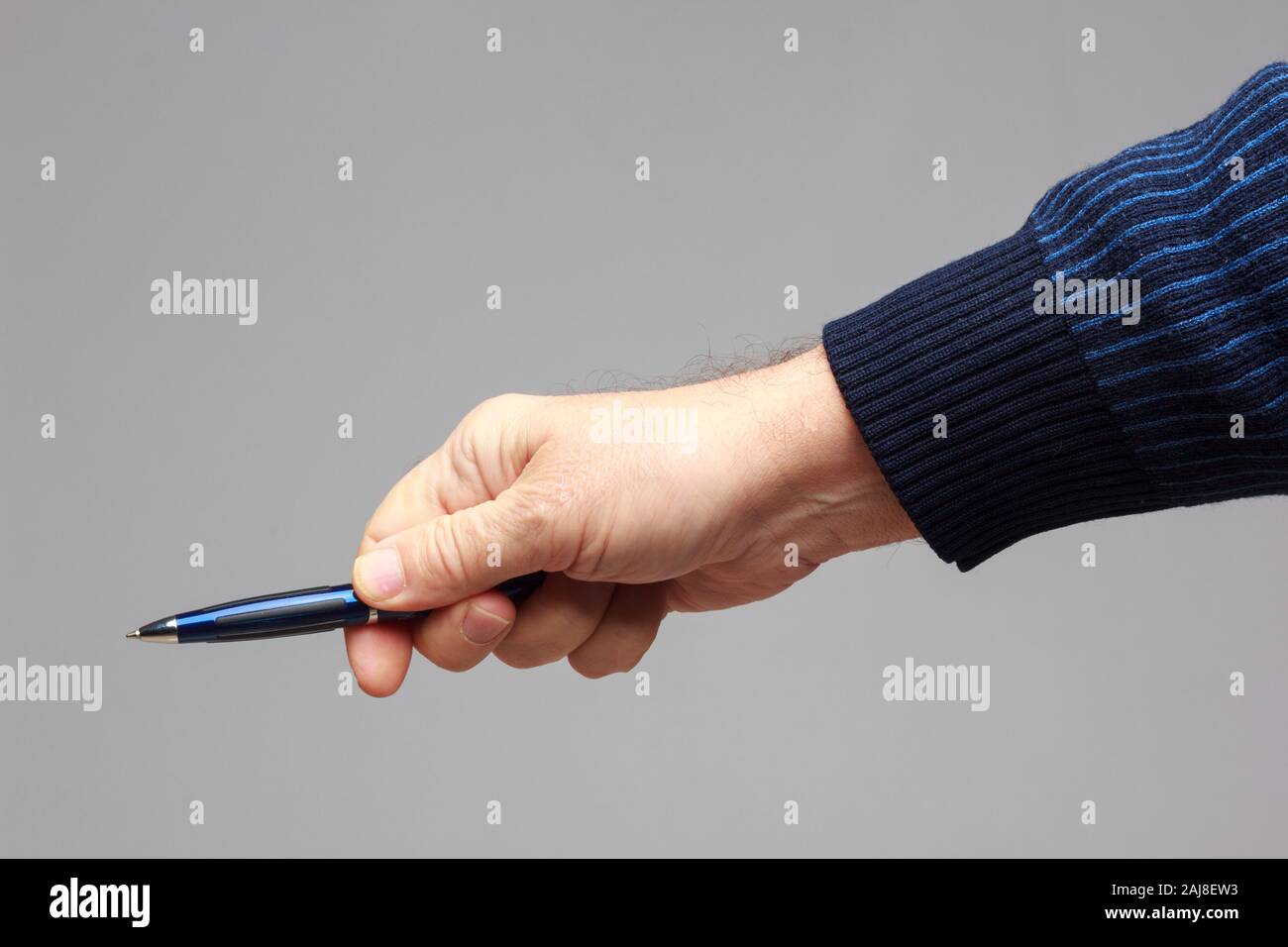 Adult hand with a pen to write ideas, sign contracts or take student ...