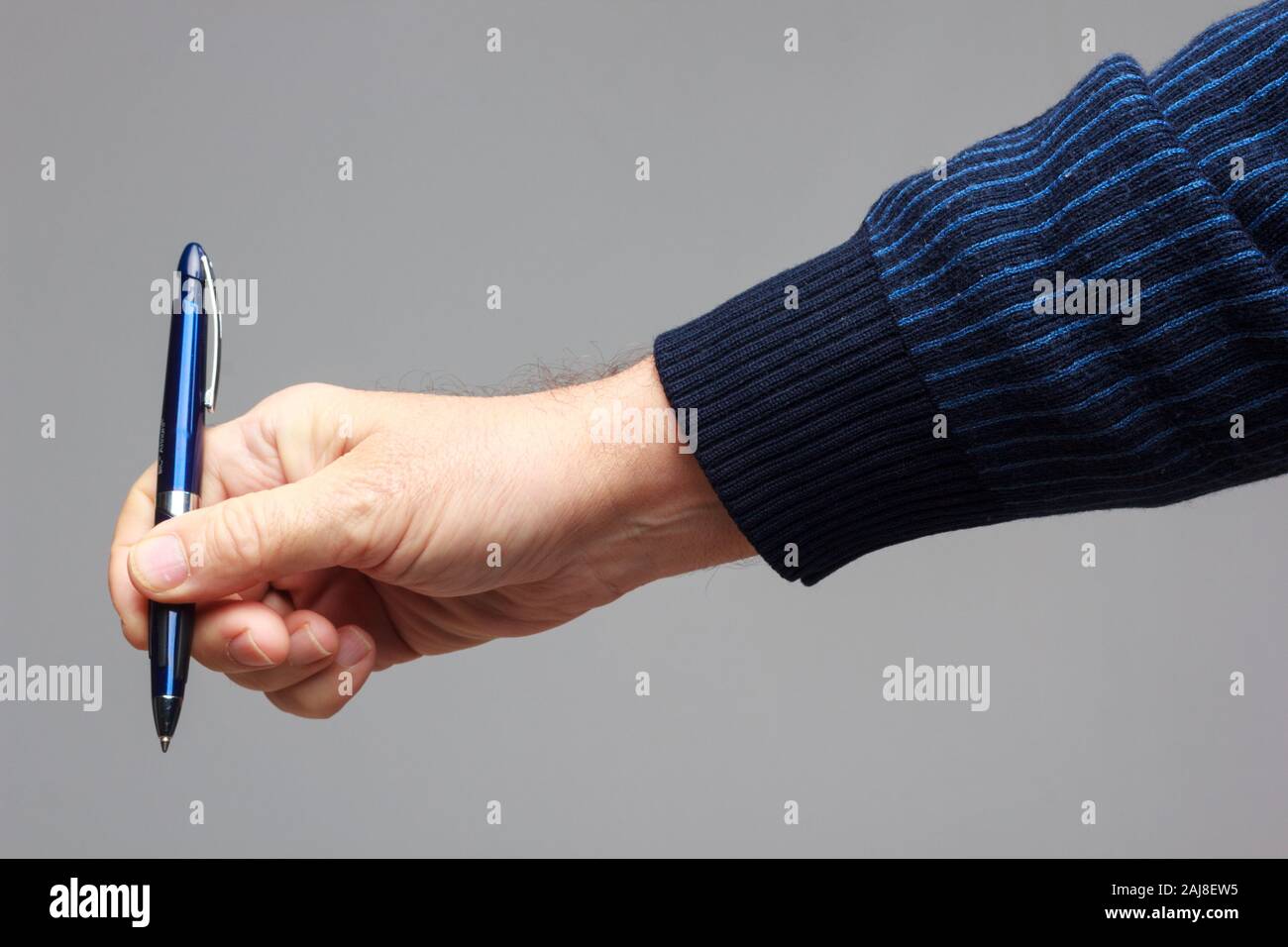 Adult hand with a pen to write ideas, sign contracts or take student ...