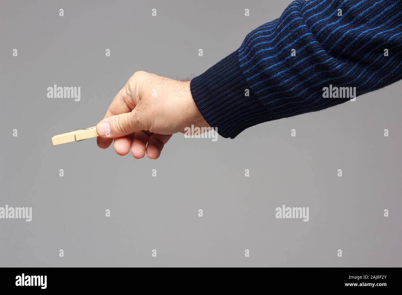 Wooden clamp, classic, to hang clothes in the hand caught by the ...