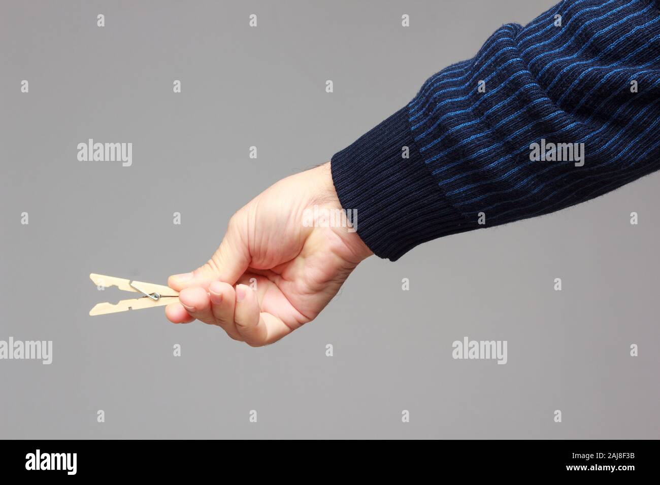 Wooden clamp, classic, to hang clothes in the hand caught by the ...