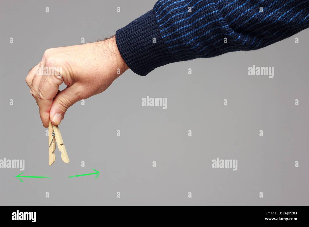 Wooden clamp, classic, to hang clothes in the hand caught by the ...