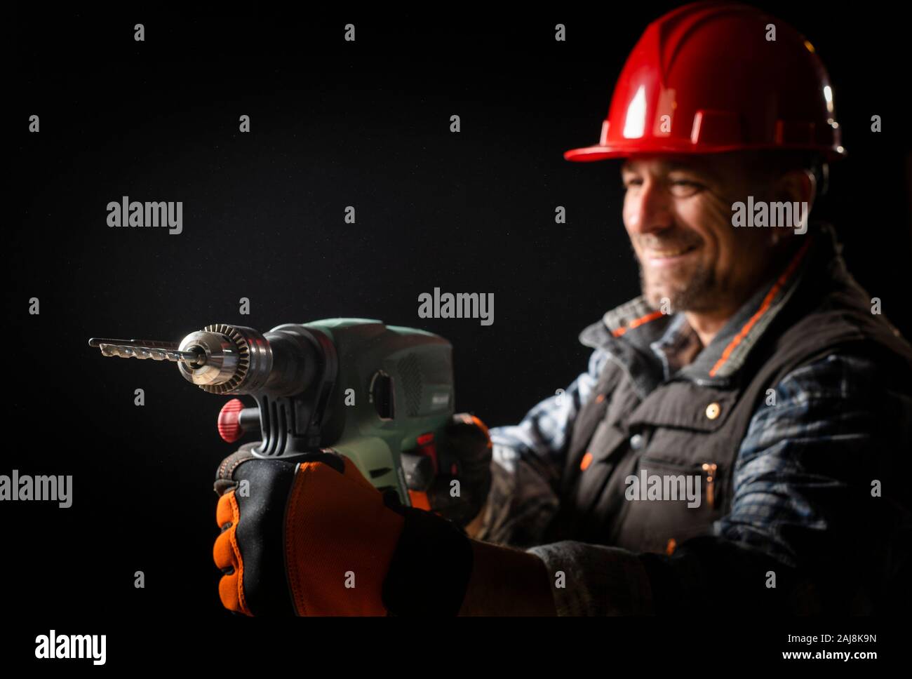 electrical worker with a pneumatic drill presses Stock Photo - Alamy