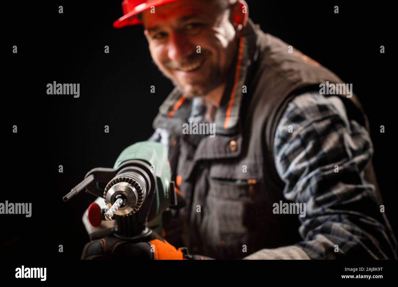 electrical worker with a pneumatic drill presses Stock Photo - Alamy