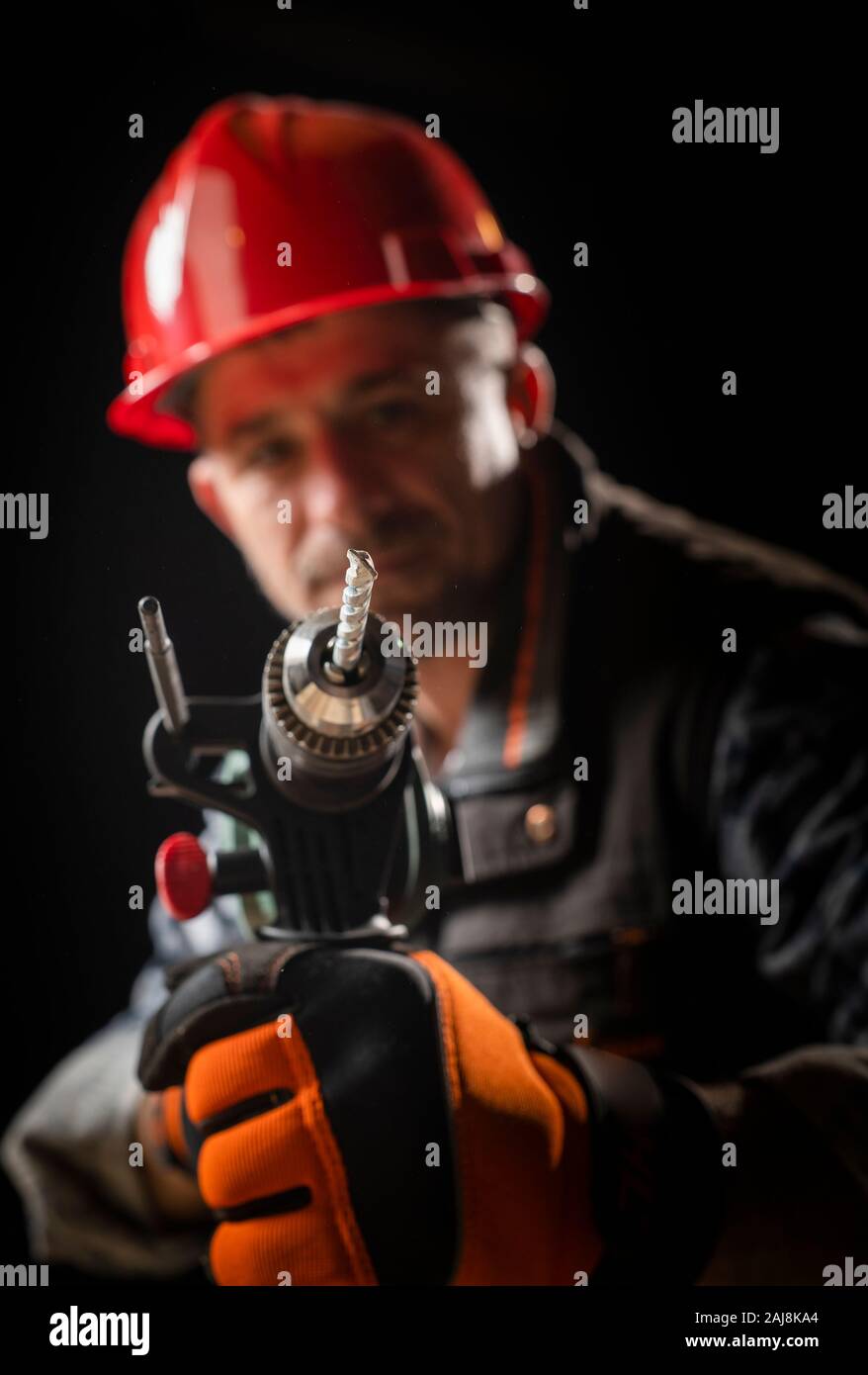 electrical worker with a pneumatic drill presses Stock Photo - Alamy