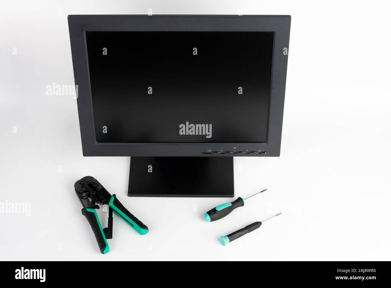 PC Lcd monitor and screwdrivers and plier on white background Stock ...