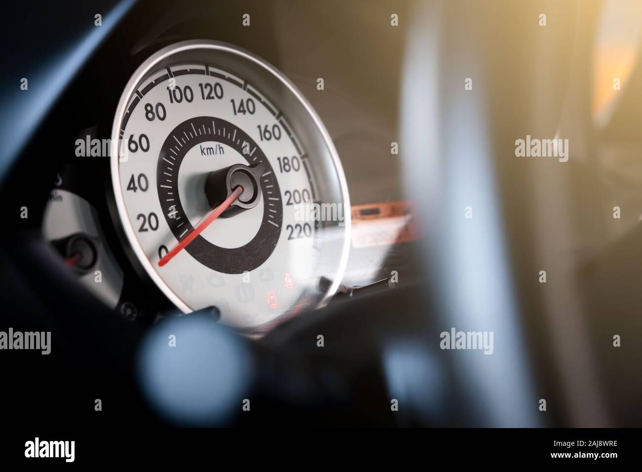 Speedometer on front car console with light flare Stock Photo - Alamy
