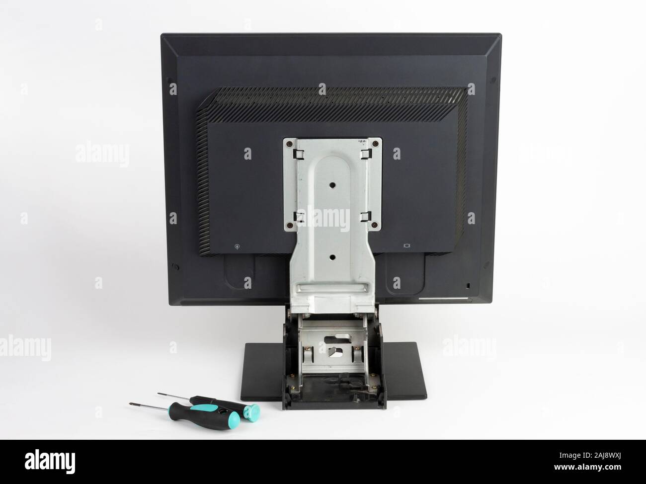 PC Lcd monitor, rear view and screwdrivers and plier on white ...