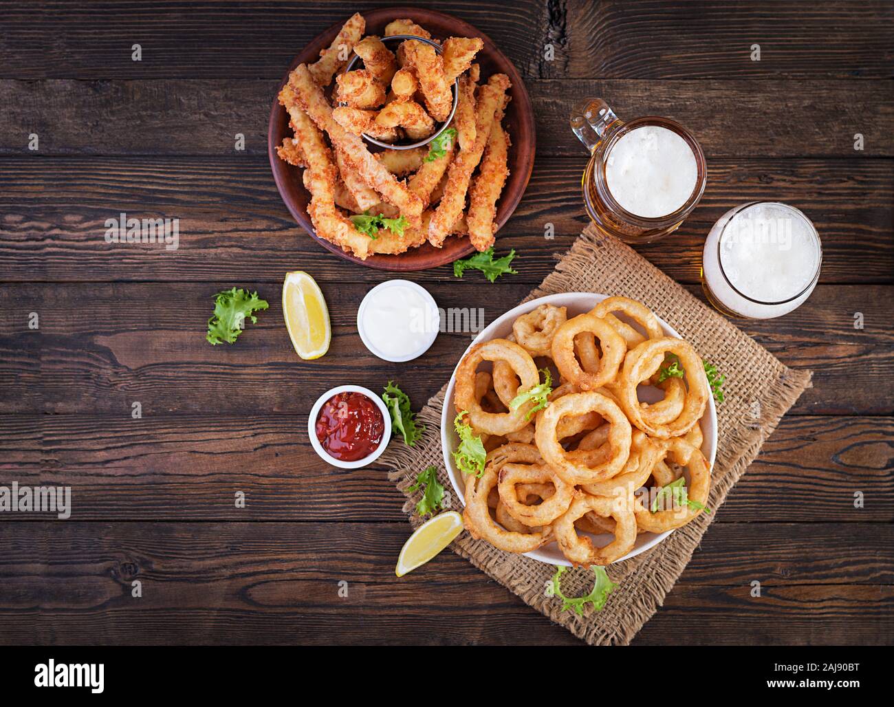Onion rings in batter with sauce and cheese sticks. Beer snacks. Top ...