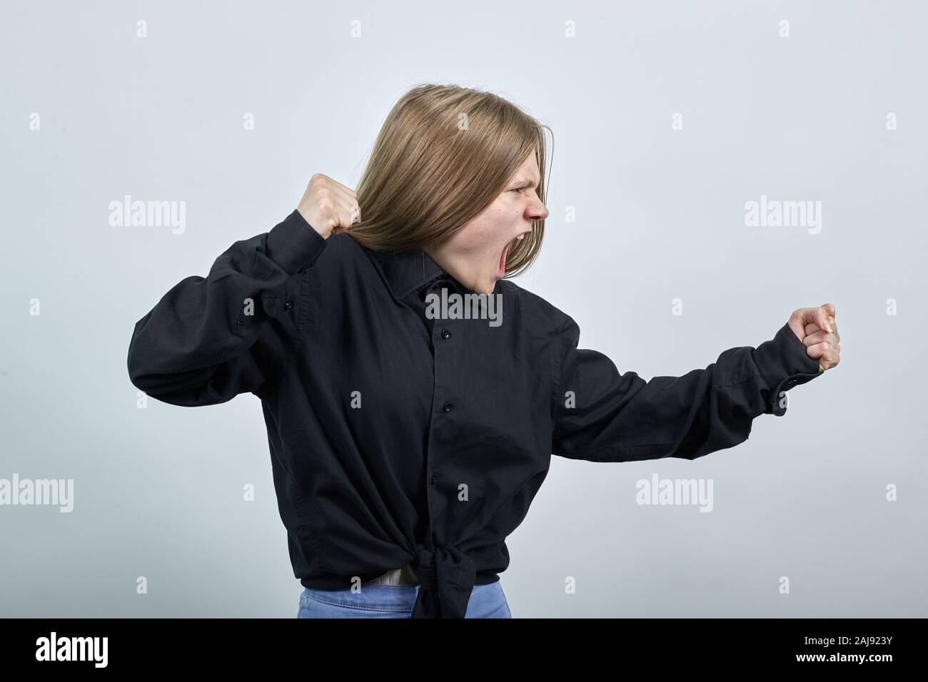 Agressive charming woman in black shirt keeping fists up, fight ...
