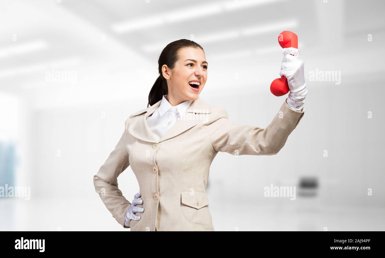 Young expressive woman screaming in retro red phone. Emotional call ...
