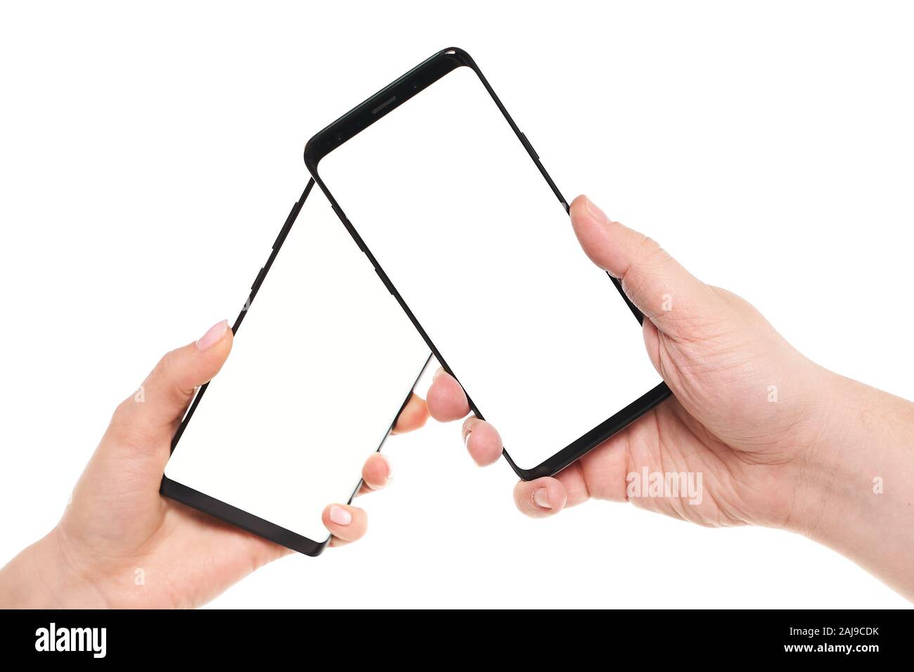 Two hands holding smartphones blank screen with modern frameless design ...