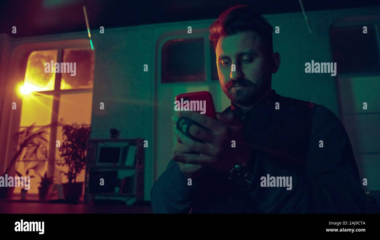 Cinematic close up portrait of handsome stylish man in neon lighted ...