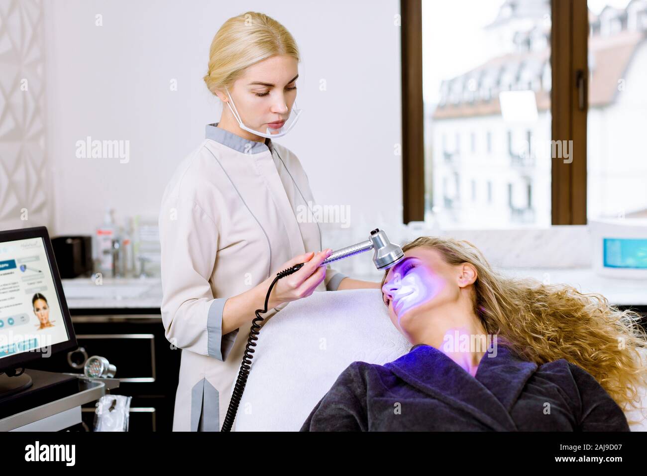 Light infrared therapy. Cosmetology face procedure. Young Woman ...