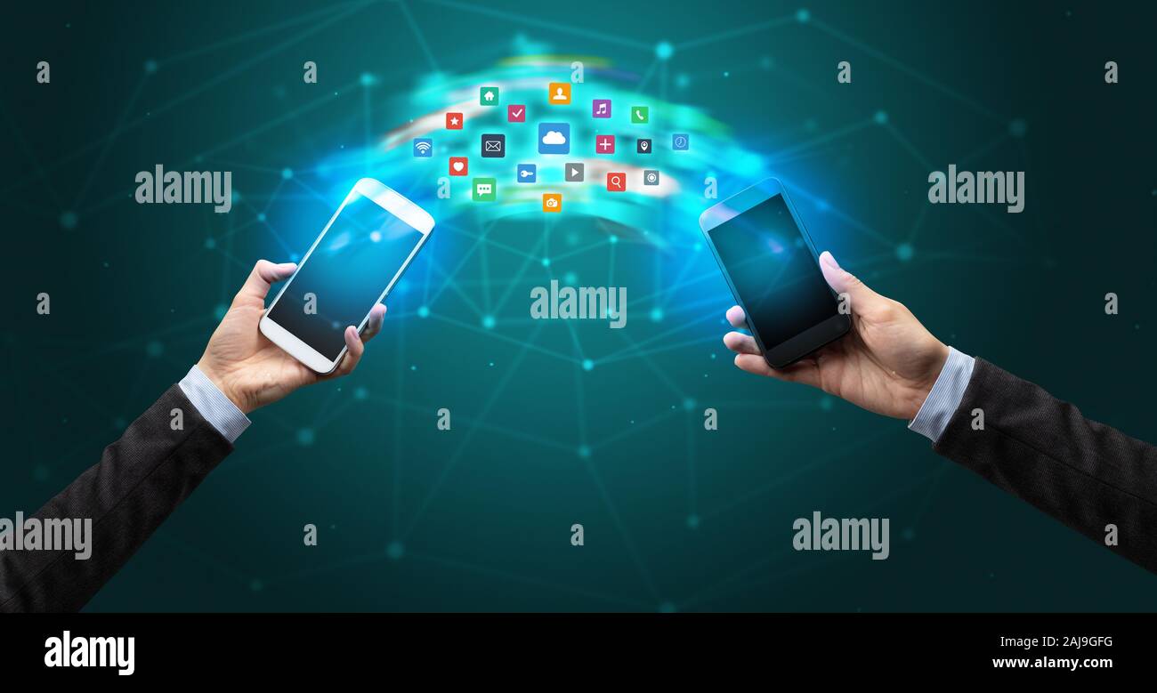 Two mobile phones syncing applications concept Stock Photo - Alamy