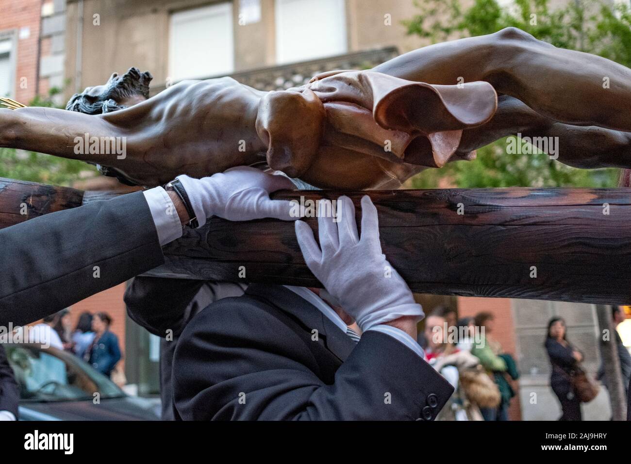 Men carry Jesus on the cross in a procession through the streets of ...
