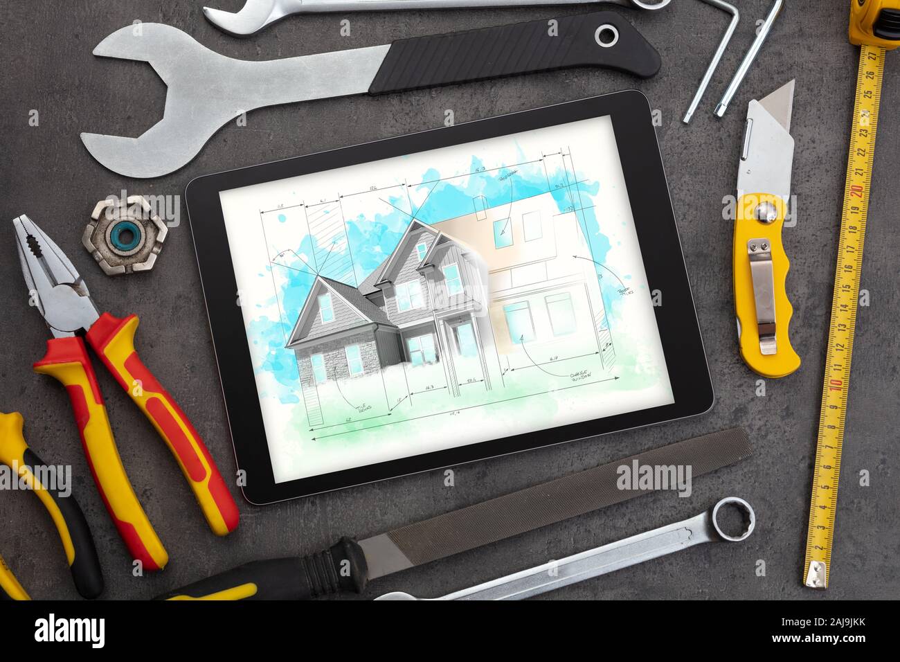 Tablet with construction tools and house plan concept Stock Photo - Alamy