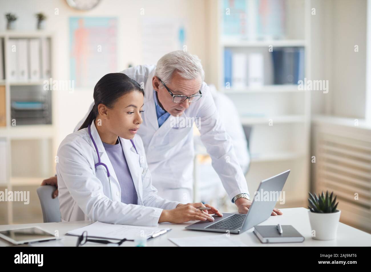 Doctor talking to patient on exam table hi-res stock photography and ...
