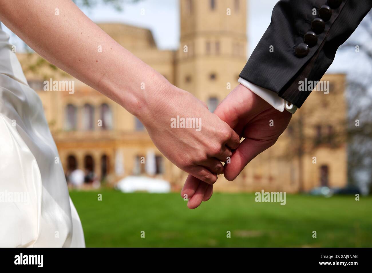 wedding couple hand in hand Stock Photo - Alamy