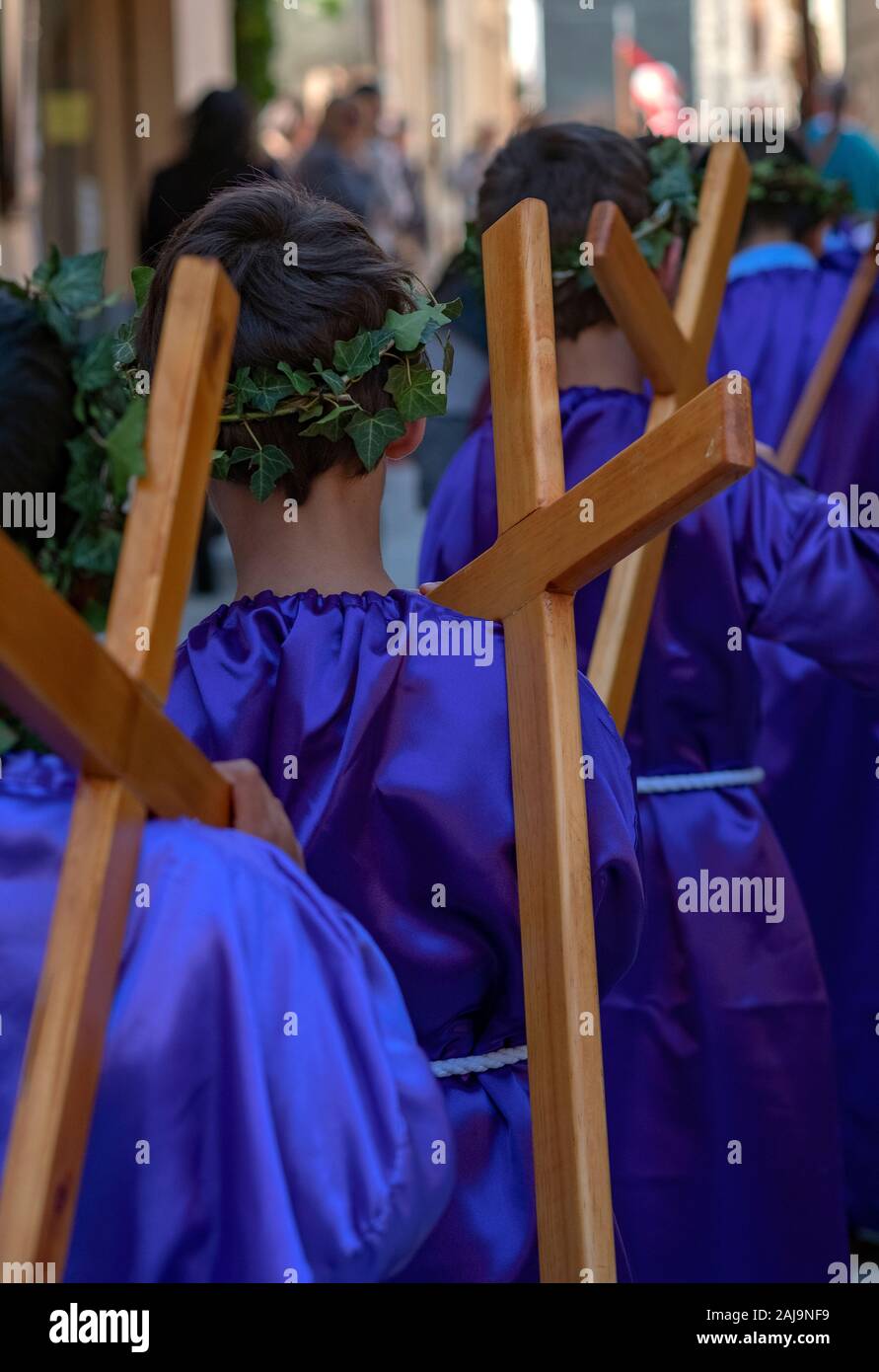 Young Catholic boys holding sticks with crosses in a procession during ...