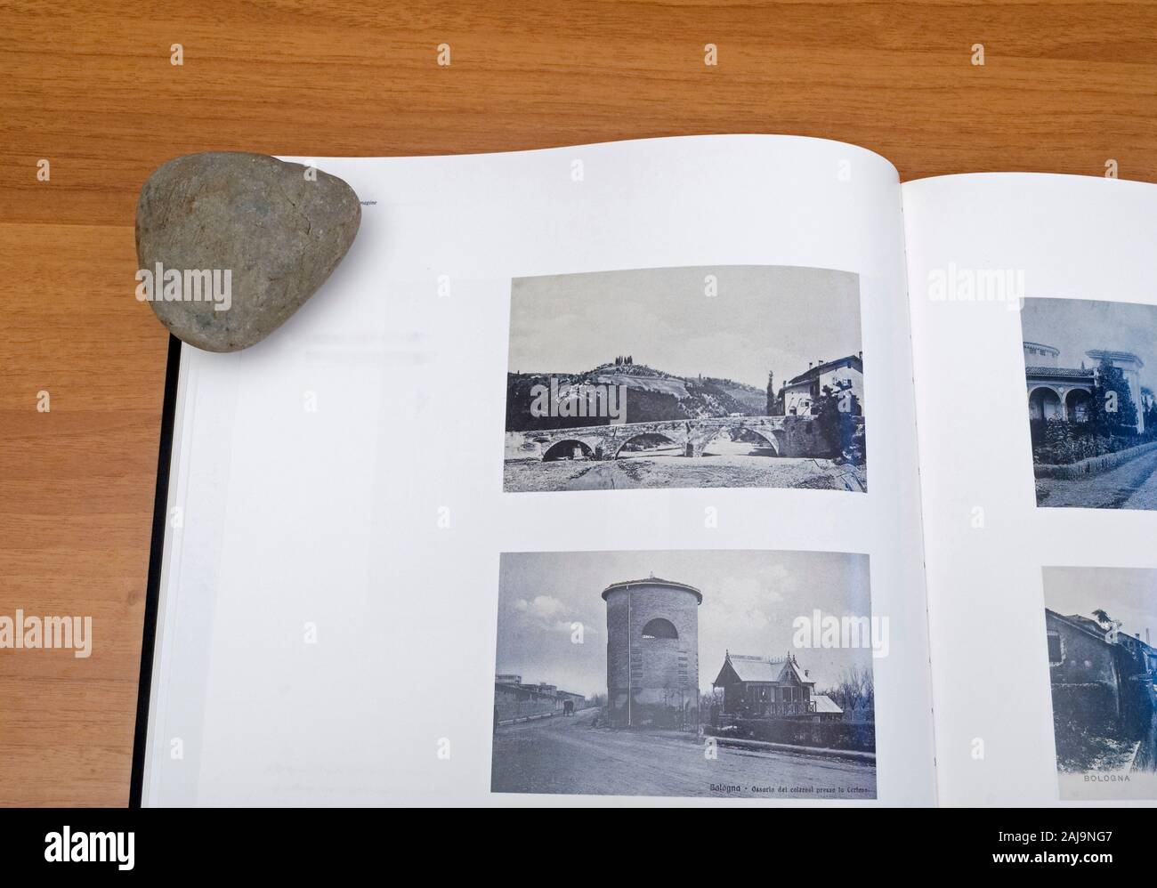 Stone on open old book Stock Photo - Alamy