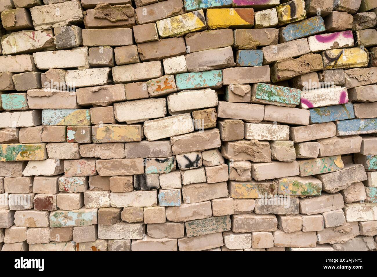 Used bricks pile stacked at construction site Stock Photo - Alamy