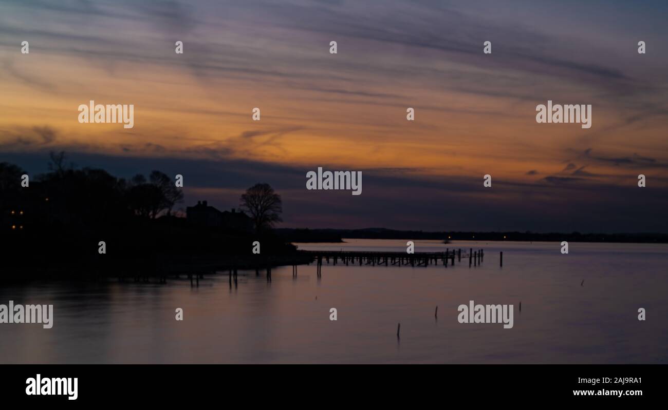 A Dock Juts Out Into a Quiet Sunset in Scituate Massachusetts Stock ...