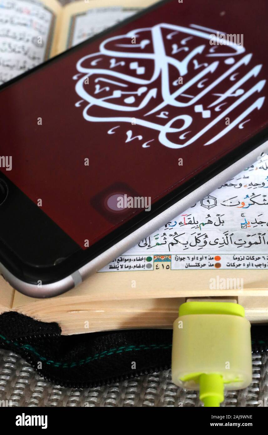 Digital quran on a smartphone and holy quran book Stock Photo - Alamy