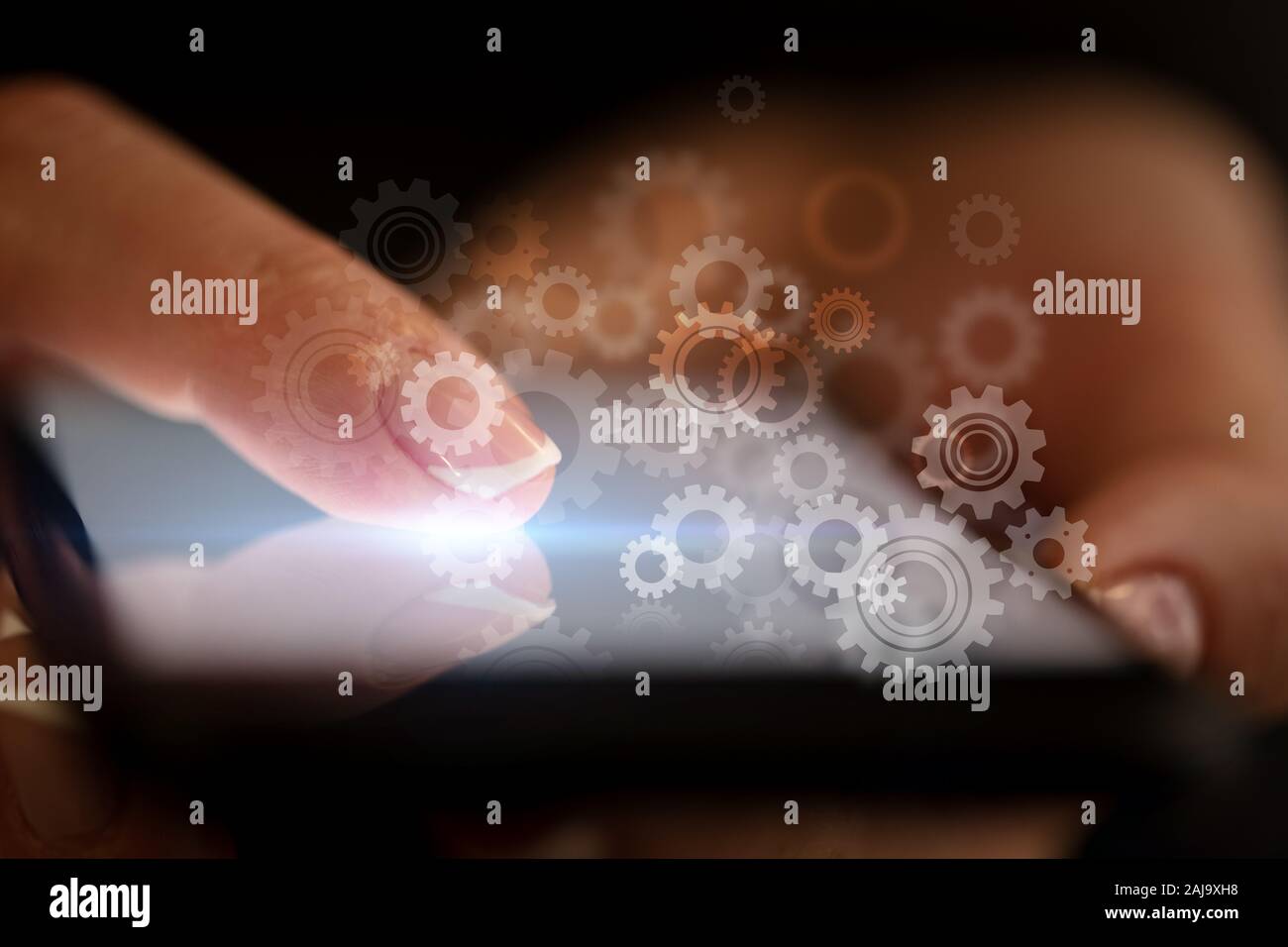 Finger setting the phone with dark background Stock Photo - Alamy