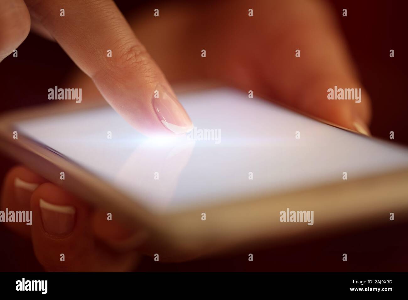 Finger touching phone with dark background with copyspace Stock Photo ...