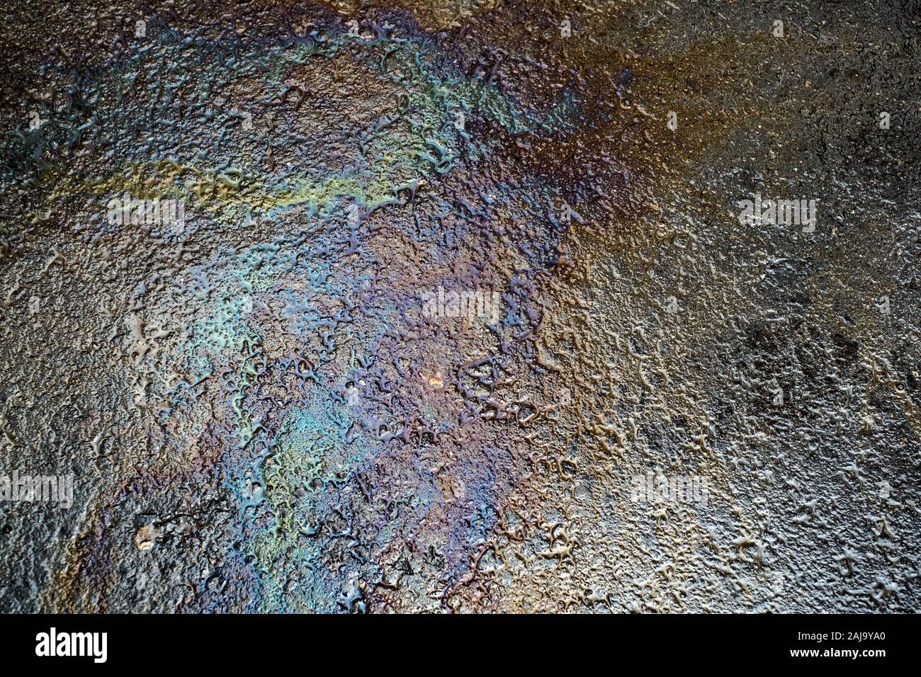 Oil stain on Asphalt road after rain, color Gasoline fuel spots on ...