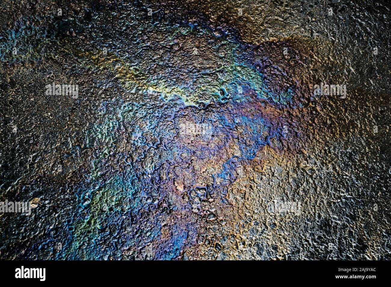 Oil stain on Asphalt road after rain, color Gasoline fuel spots on ...