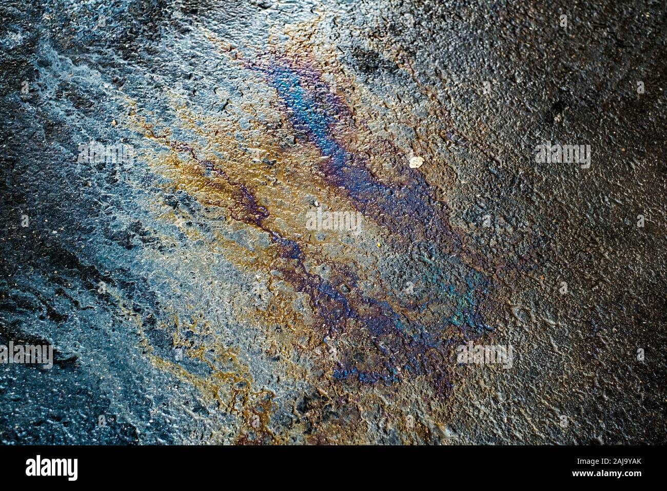 Oil stain on Asphalt road after rain, color Gasoline fuel spots on ...