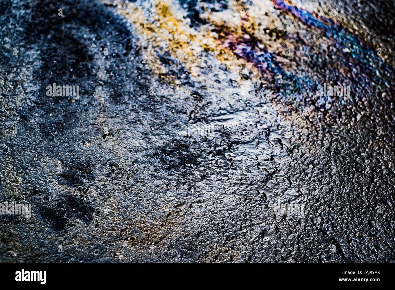 Oil stain on Asphalt road after rain, color Gasoline fuel spots on ...