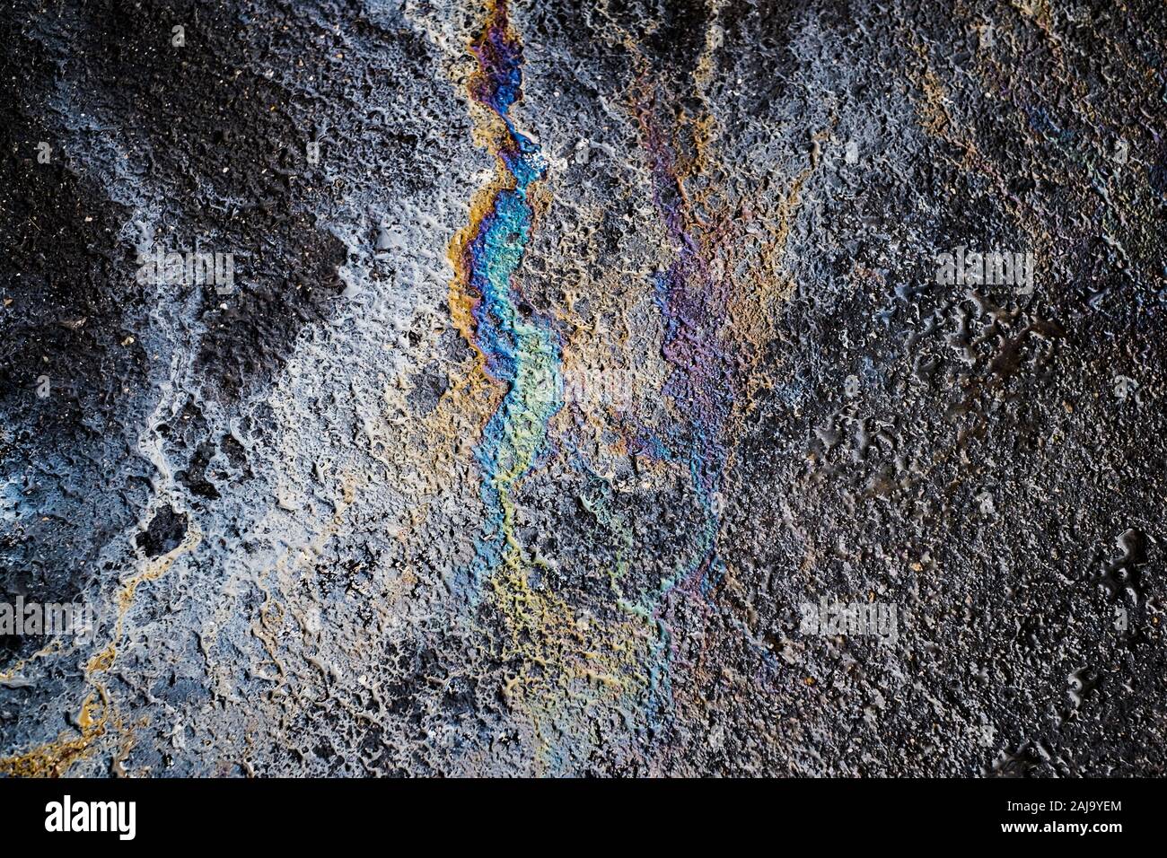 Oil stain on Asphalt road after rain, color Gasoline fuel spots on ...