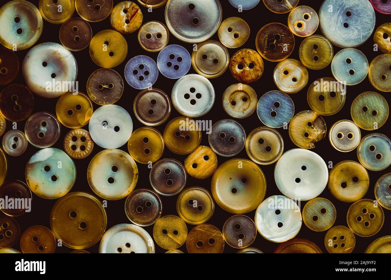 old vintage plastic buttons on black background Stock Photo - Alamy
