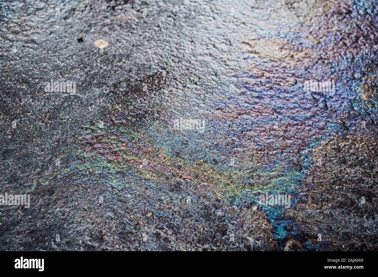 Oil stain on Asphalt road after rain, color Gasoline fuel spots on ...
