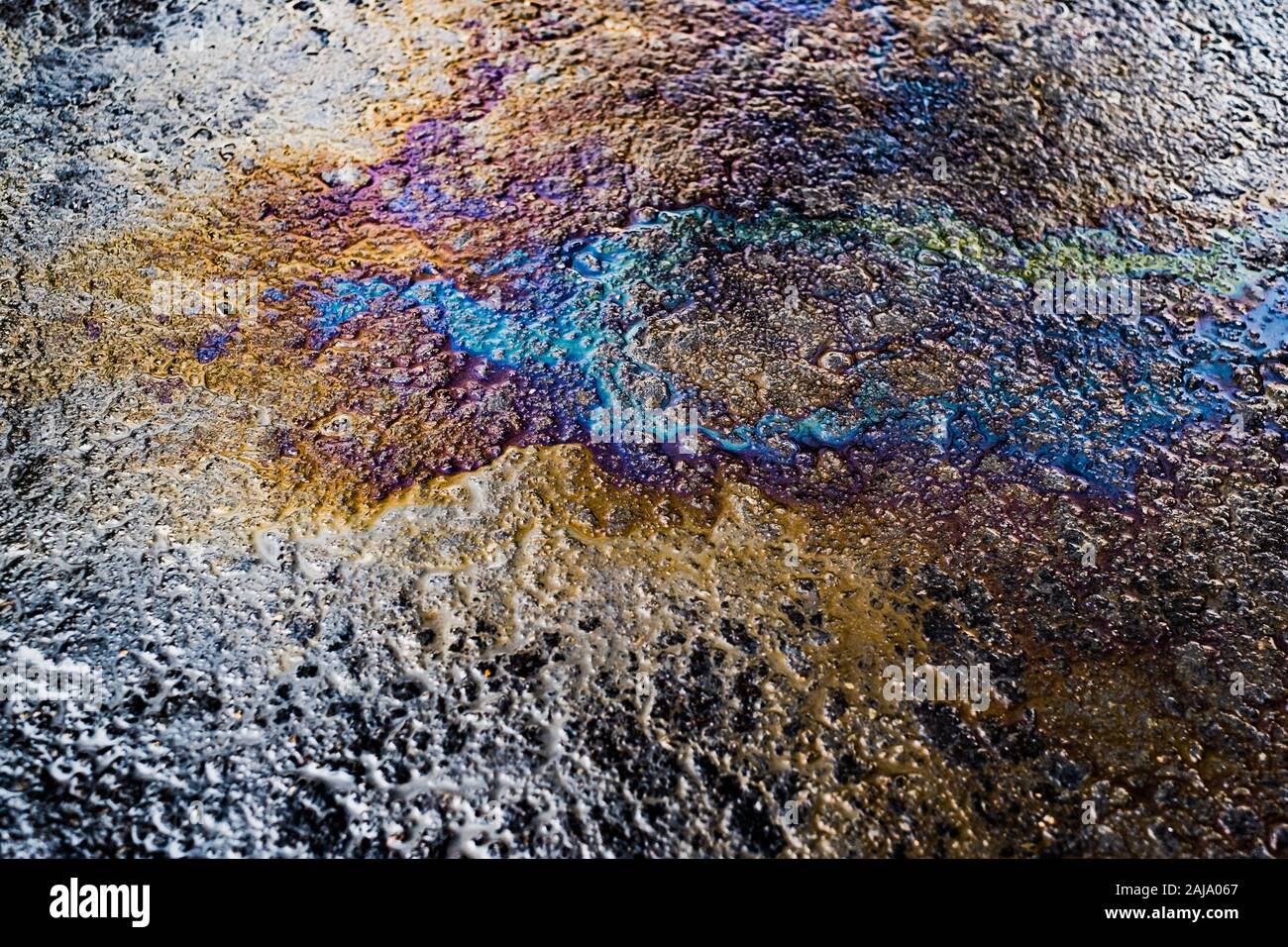 Oil stain on Asphalt road after rain, color Gasoline fuel spots on ...