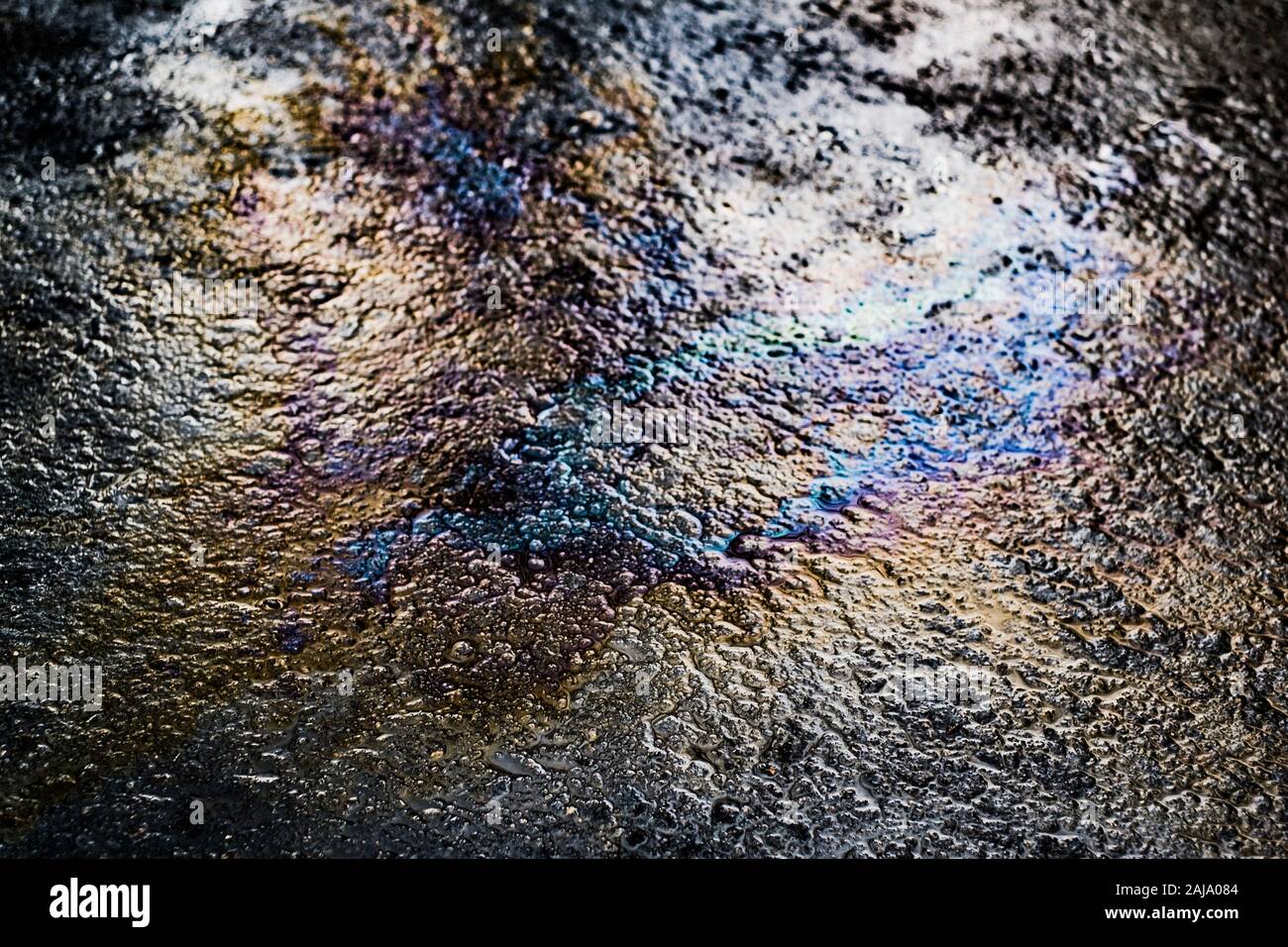 Oil stain on Asphalt road after rain, color Gasoline fuel spots on ...